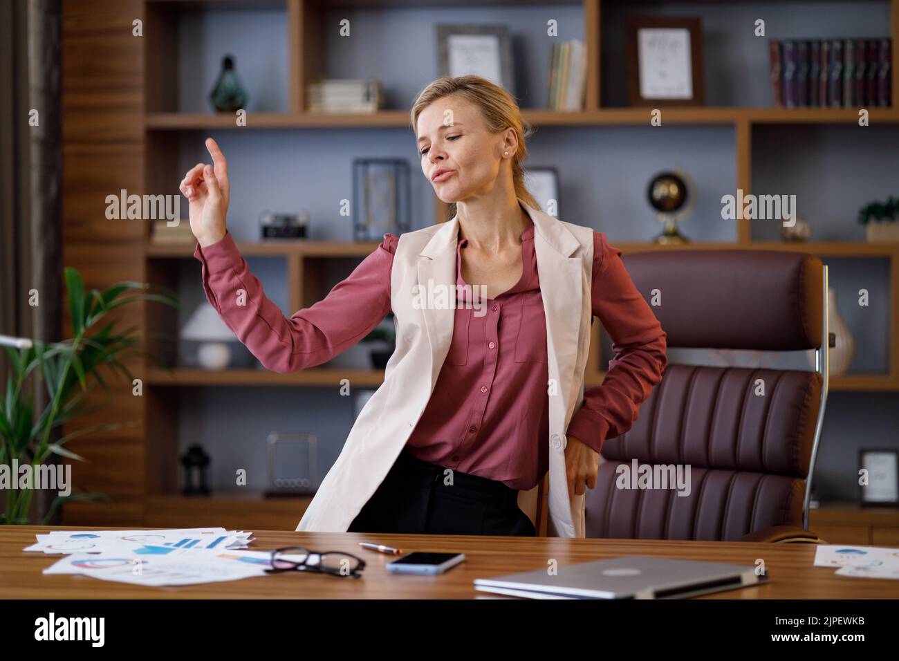 Female trader dancing at workplace. Happy businesswoman got positive ...