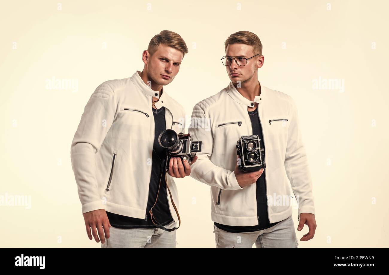 twin brothers men look alike use vintage photo camera, photographing ...