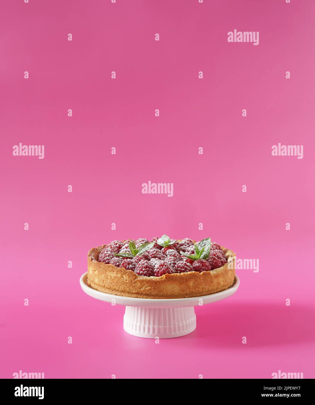cheesecake with fresh raspberry on cake stand on pink background, free ...