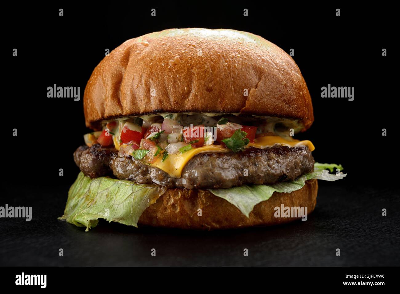 Hamburger with beef and hot vegetables on a black background Stock ...