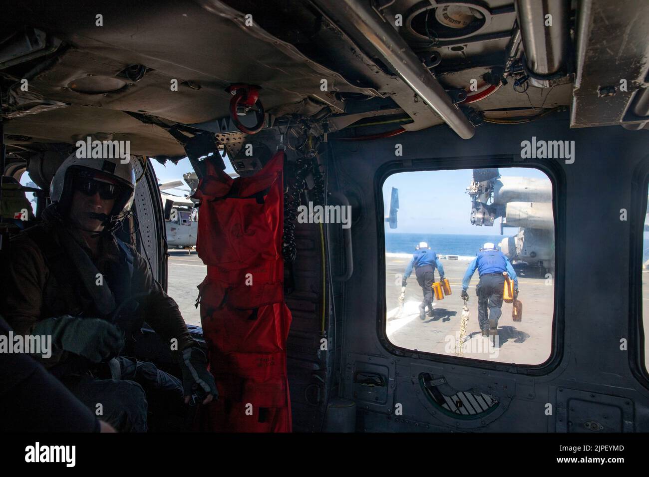 220809-N-IV962-3019 Sailors finish taking off tie-down chains from an ...