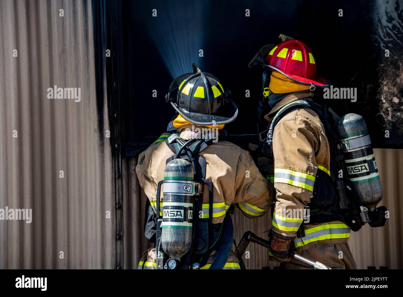 Local firefighters from the Green Valley Fire District power a firehose ...