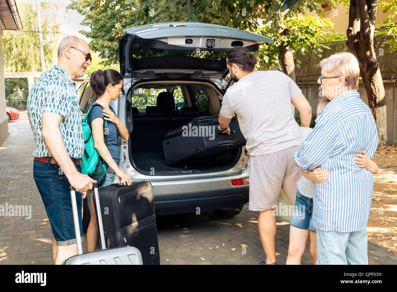 Big european family leaving on vacation journey and loading baggage in ...
