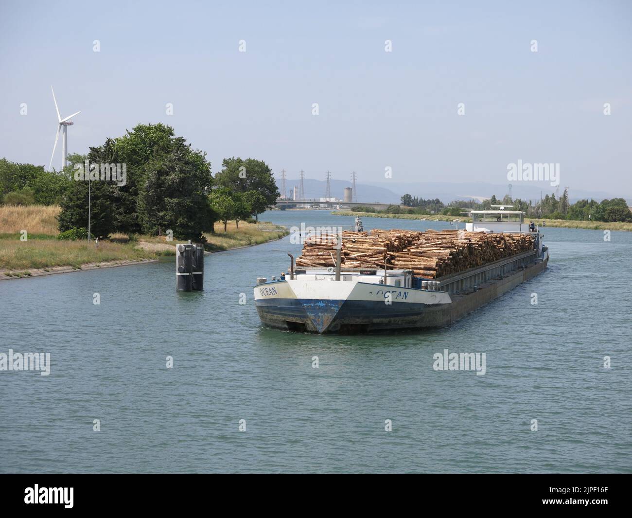 The cargo boat "Ocean" is laden with a load of timber logs being ...