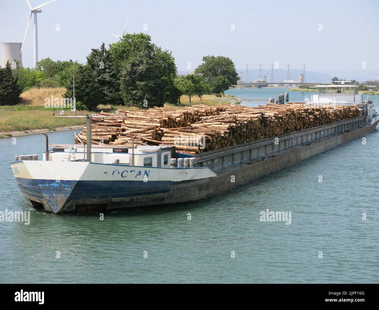The cargo boat "Ocean" is laden with a load of timber logs being ...