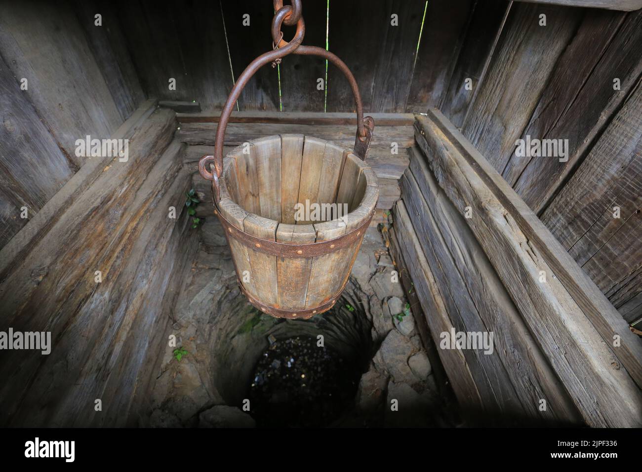 Old wooden bucket in a well close-up Stock Photo - Alamy
