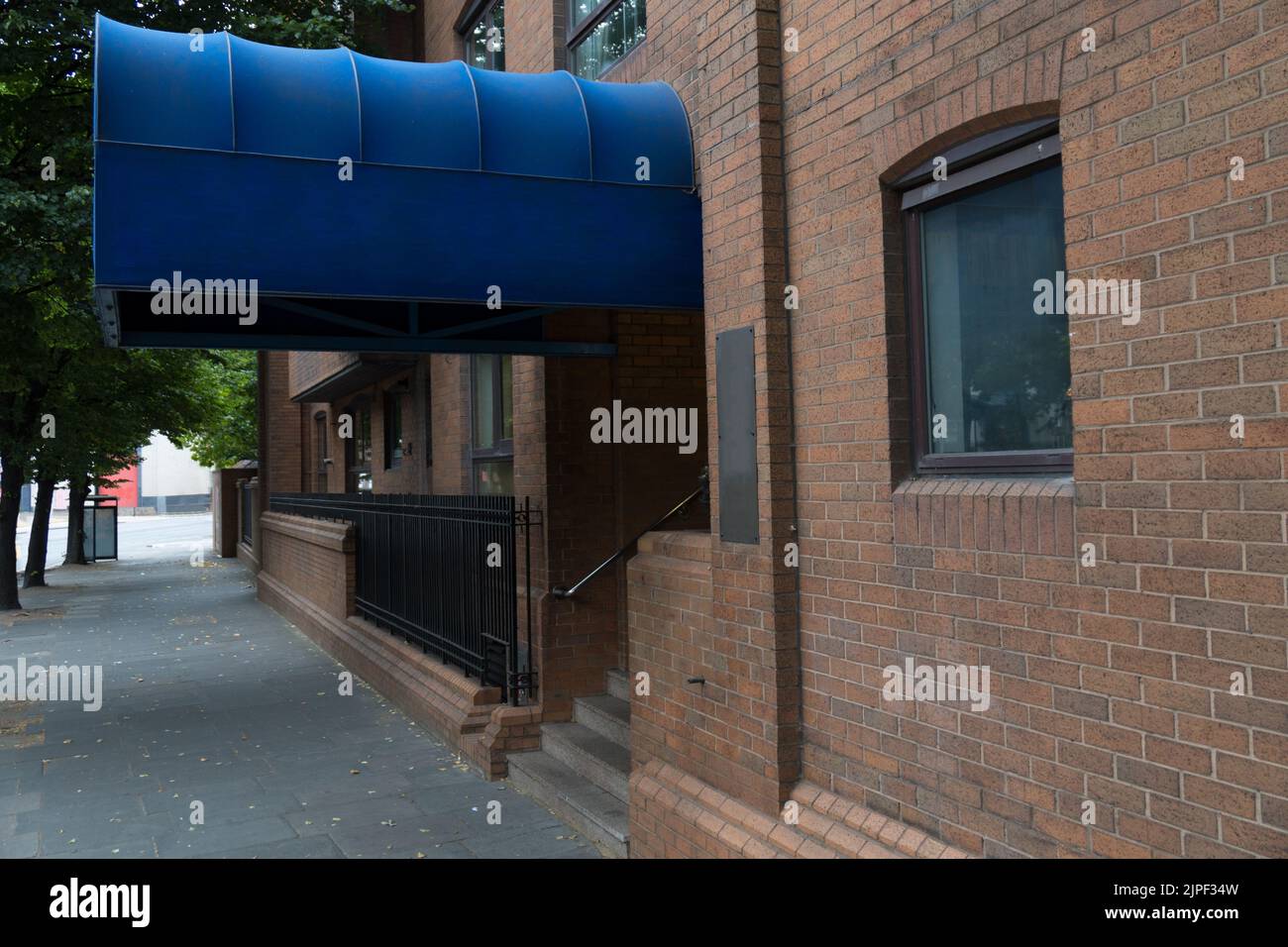 Brick tenement apartment building or hotel with representative entrance ...