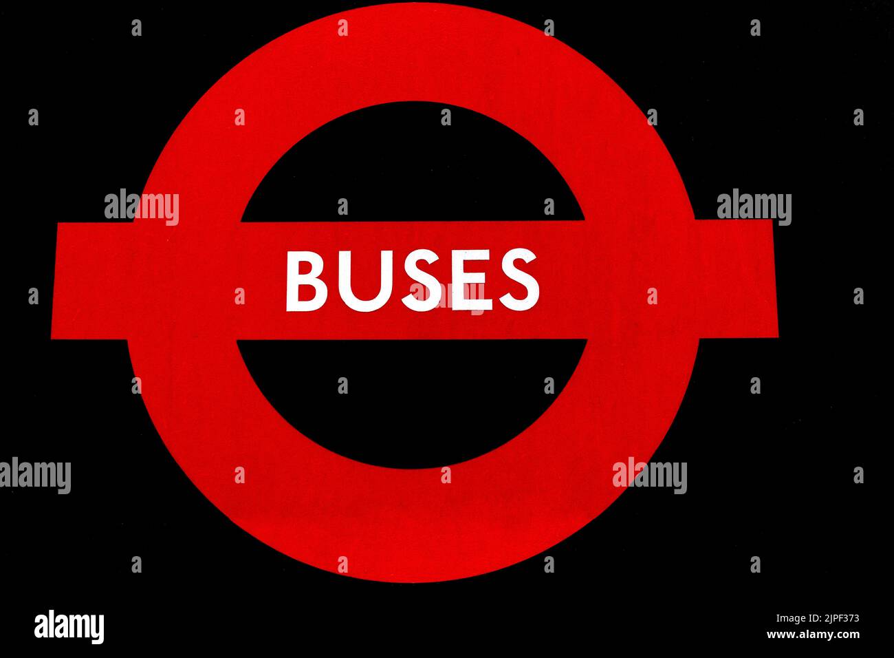 red sign on a black background with the word buses to indicate public ...