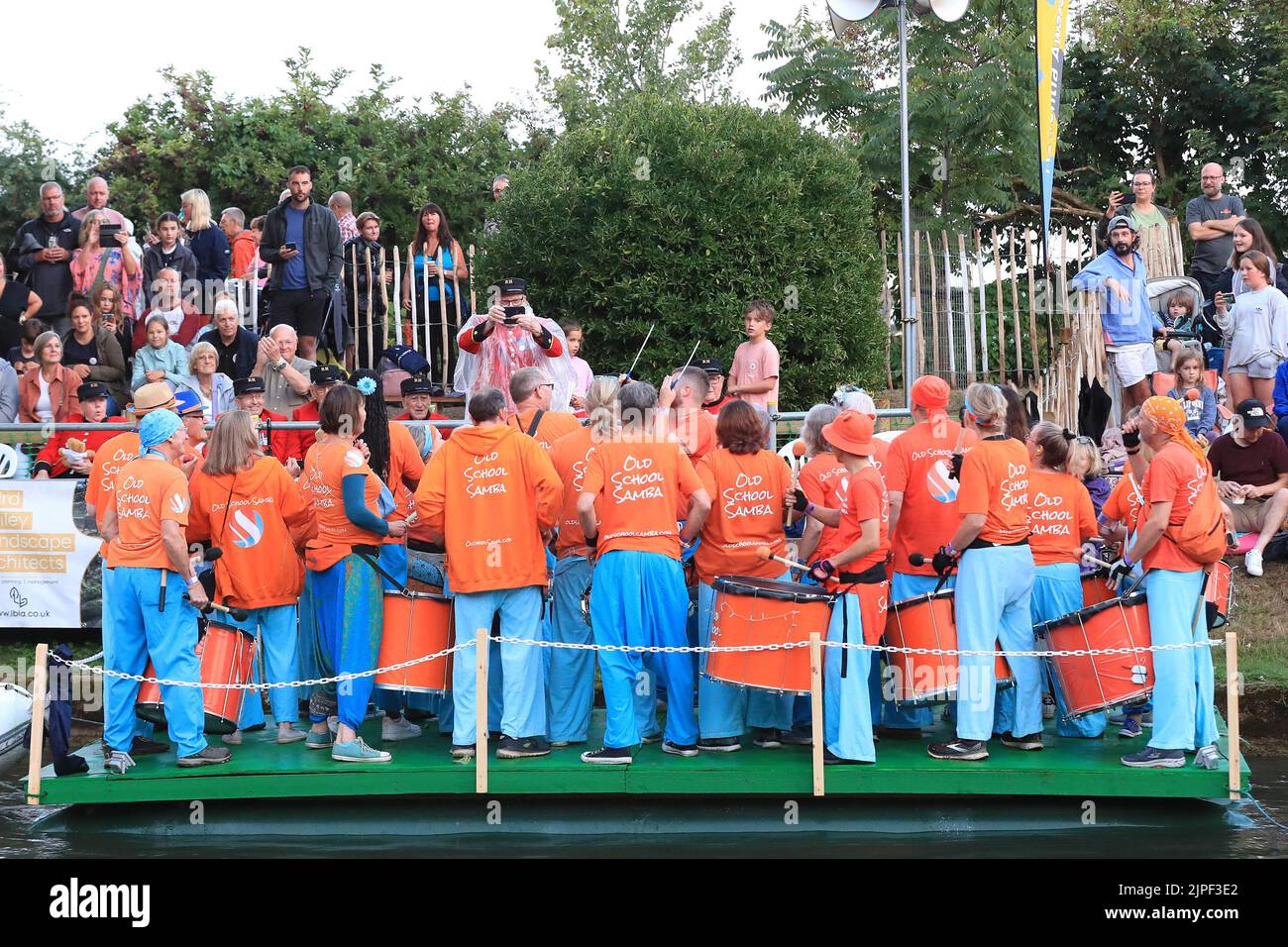 A Chelsea Pensioner takes a photo as the Old School Samba float passes ...