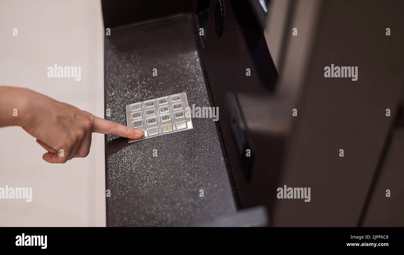 Faceless woman dialing bank card pin at ATM Stock Photo - Alamy