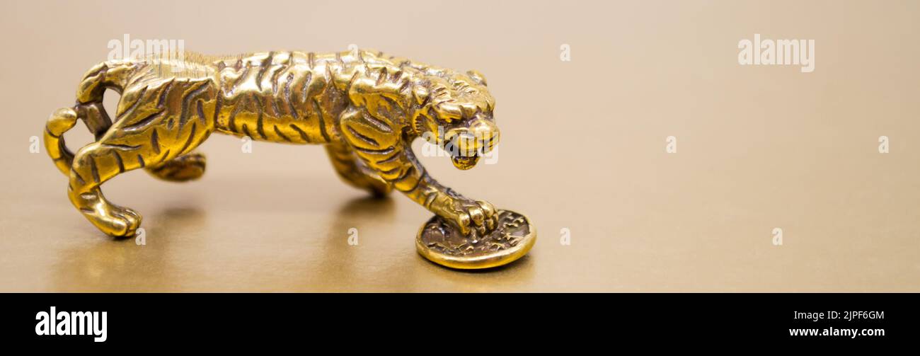 Banner with a bronze figure of a tiger with a coin - the symbol of ...
