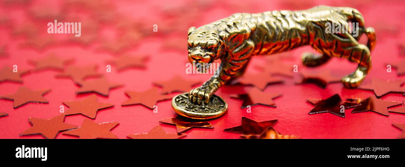 Banner with a bronze figure of a tiger with a coin - the symbol of ...