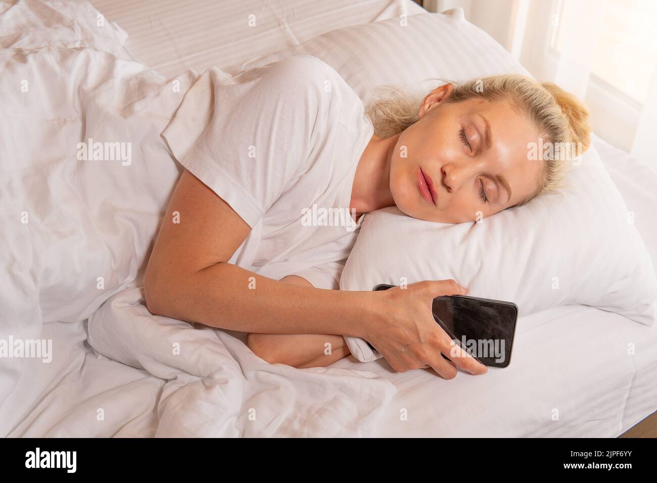 Woman sleeping mobile phone hi-res stock photography and images - Alamy
