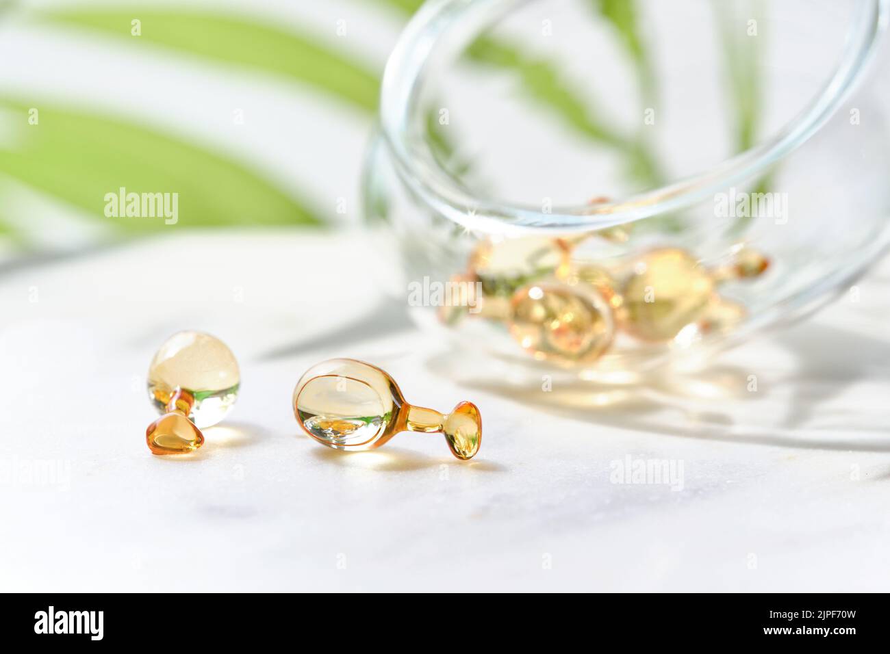 Serum capsules for healthy skin. Close-up on transparent bottle with ...