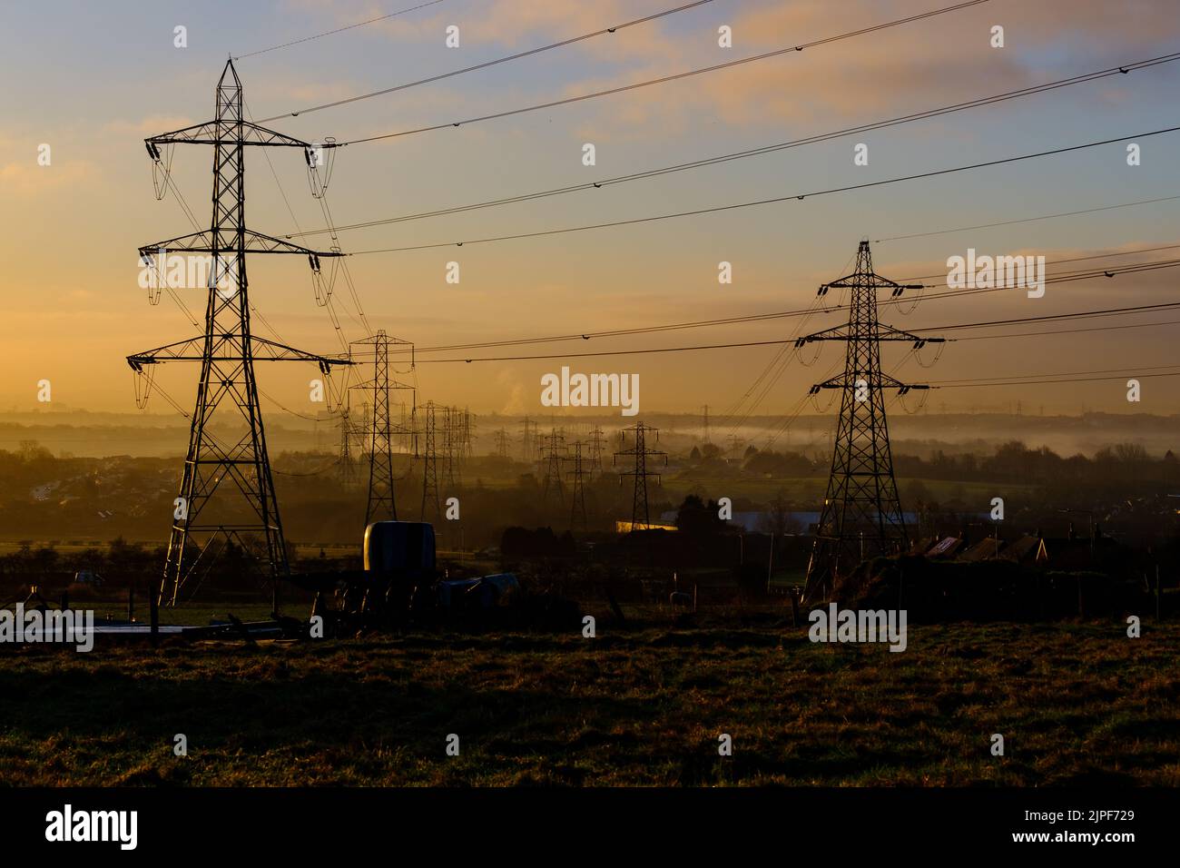 Early morning sky. Pylons and lines spanning the countryside in North ...