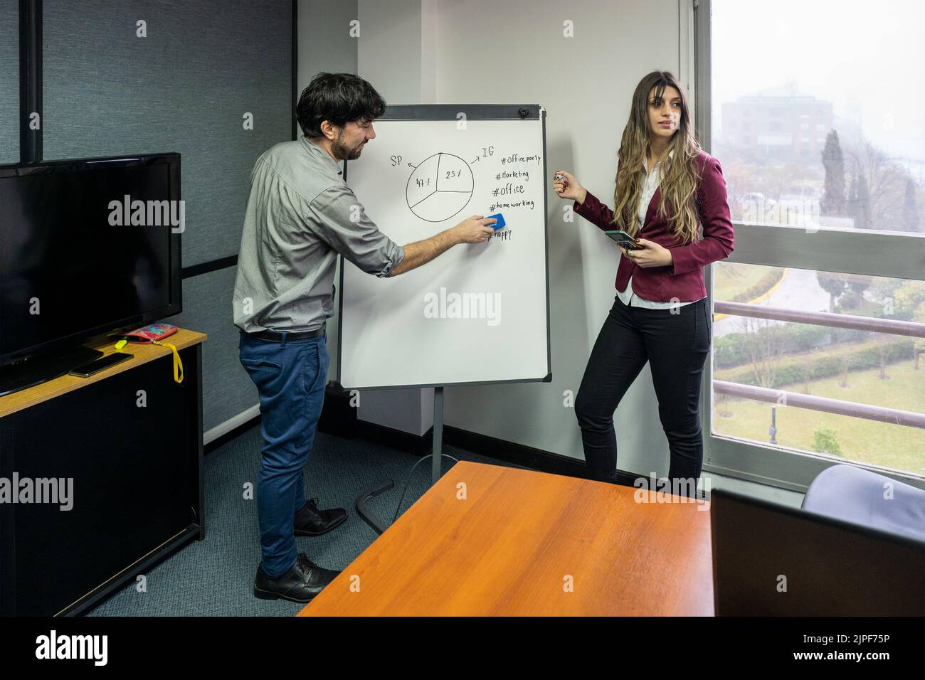 Employees making a presentation to their office colleagues in the ...
