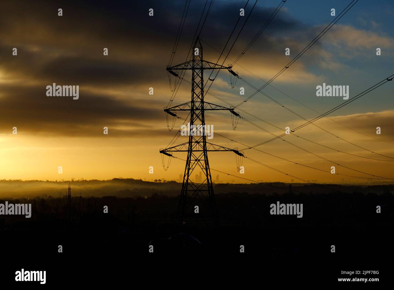 Early morning sky. Pylons and lines spanning the countryside in North ...