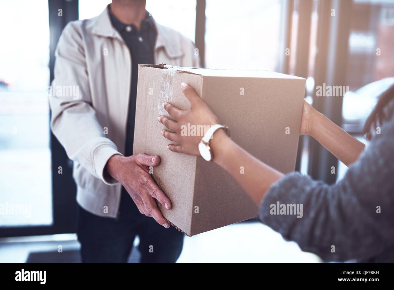 Delivering packages safely is what I do. a unrecognizable man handing ...