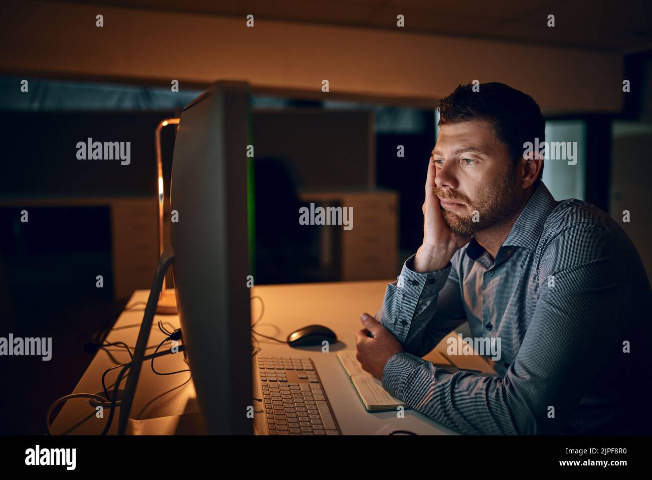 The late shift has him in a dull and dreary mood. a young businessman ...