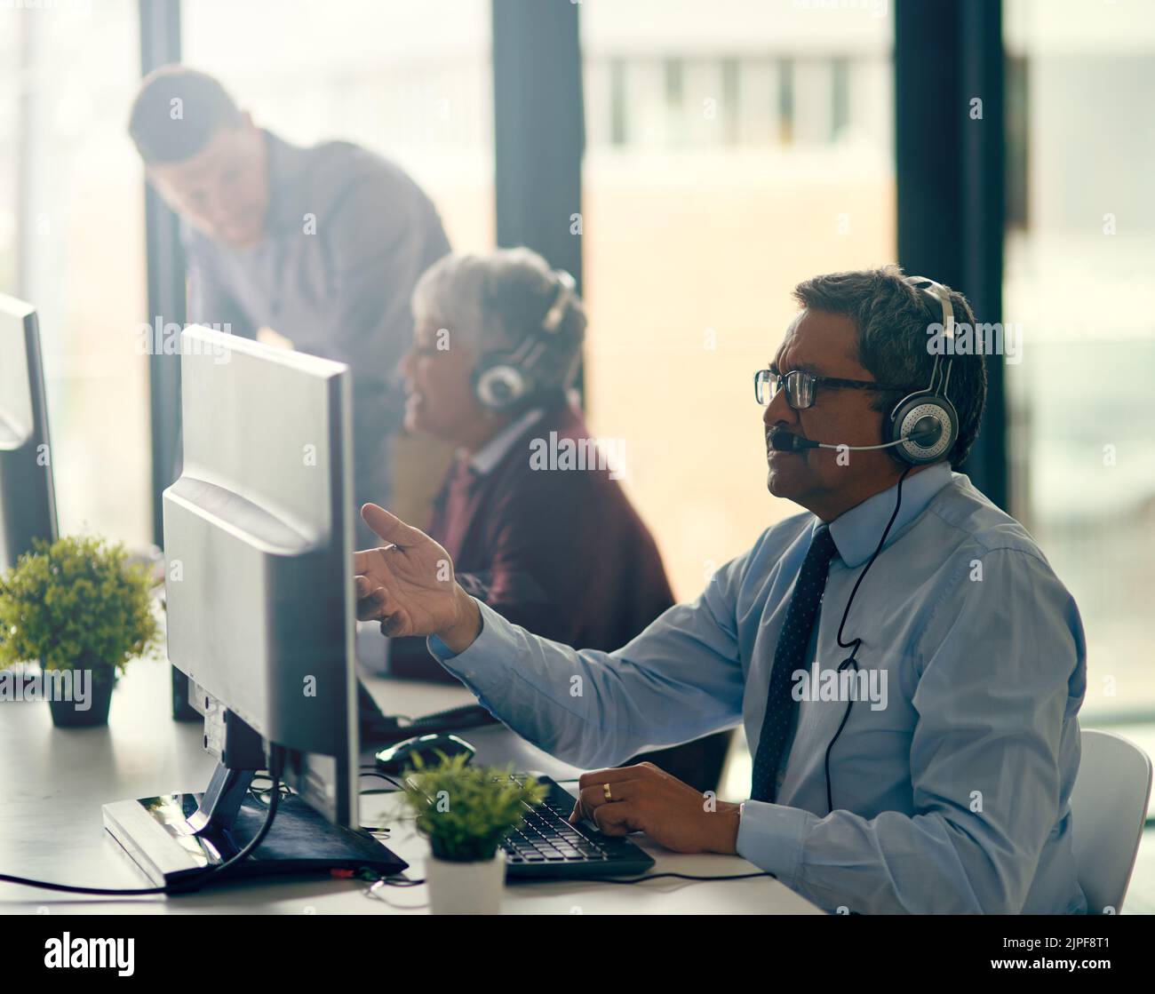 Logging and solving inquiries. call centre agents working in an office ...