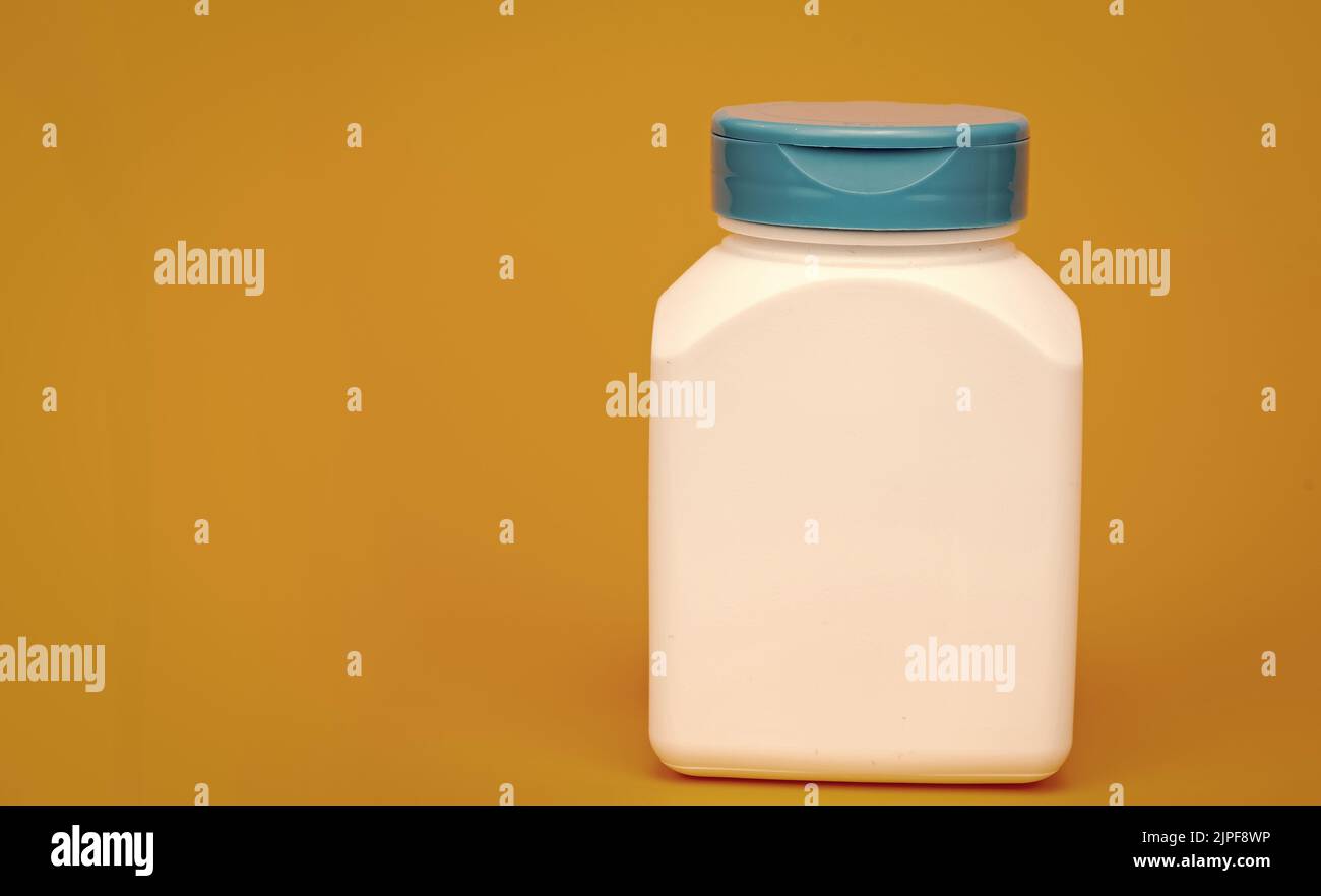 multivitamin bottle on yellow background. copy space. food supplement ...