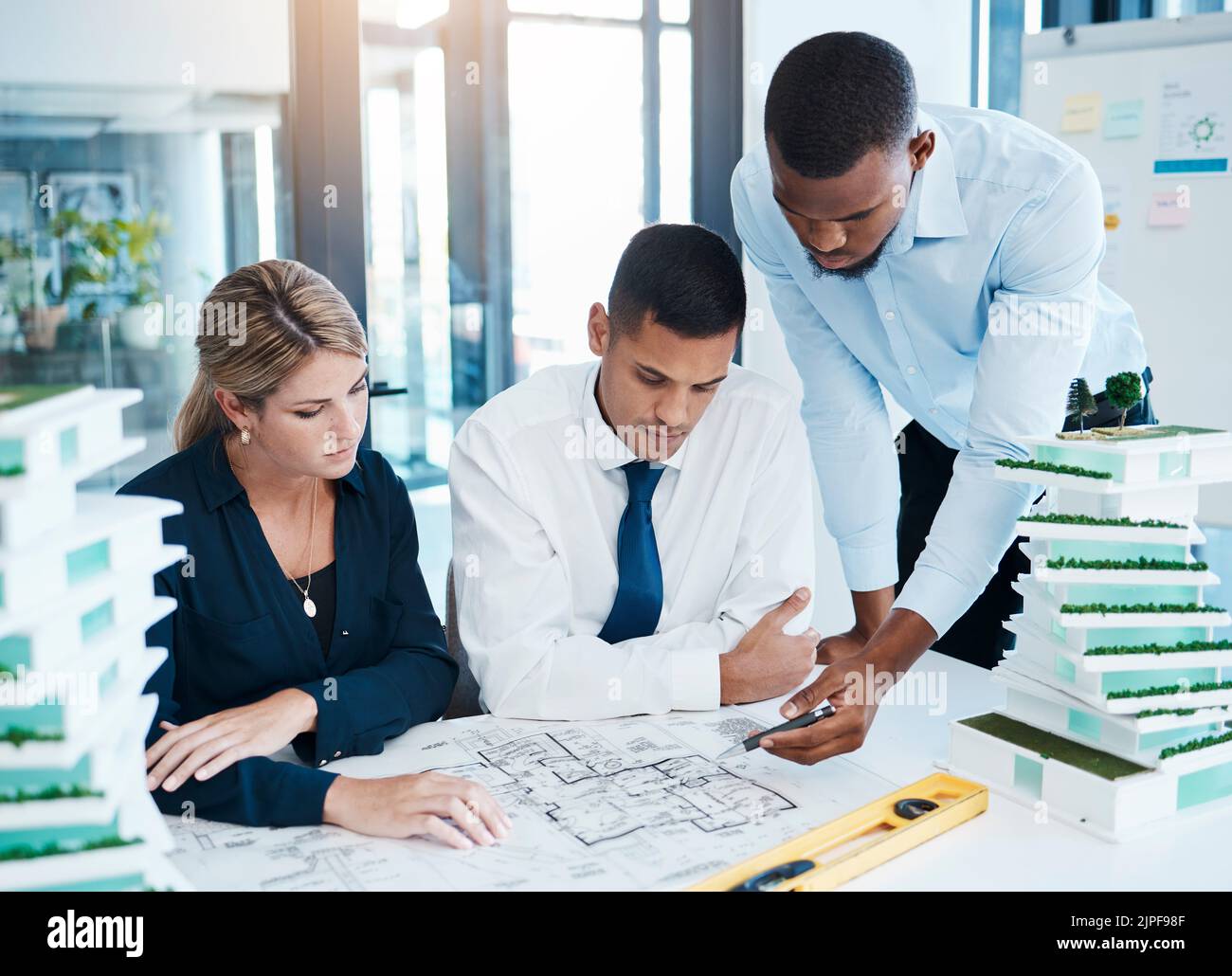 Designers and architects working on construction plan, planning with ...