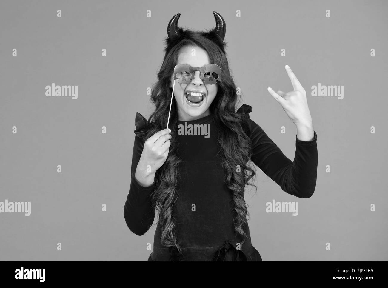 Happy girl on Halloween wear funny carnival costume and glasses indoor ...