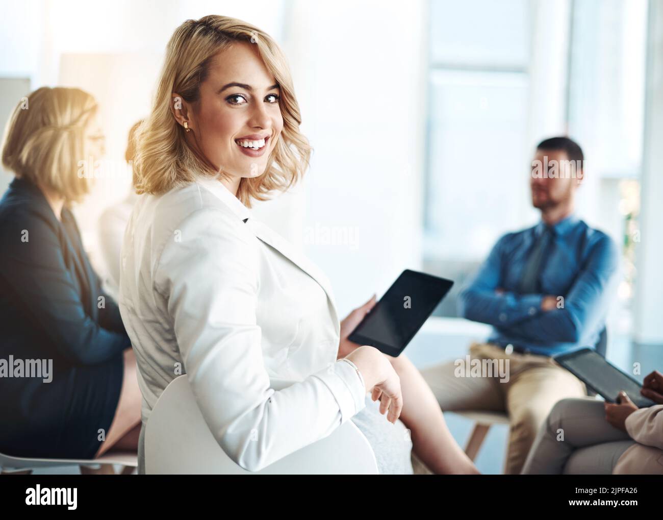 Im enjoying this meeting. Cropped portrait of an attractive young businesswoman sitting in the ...