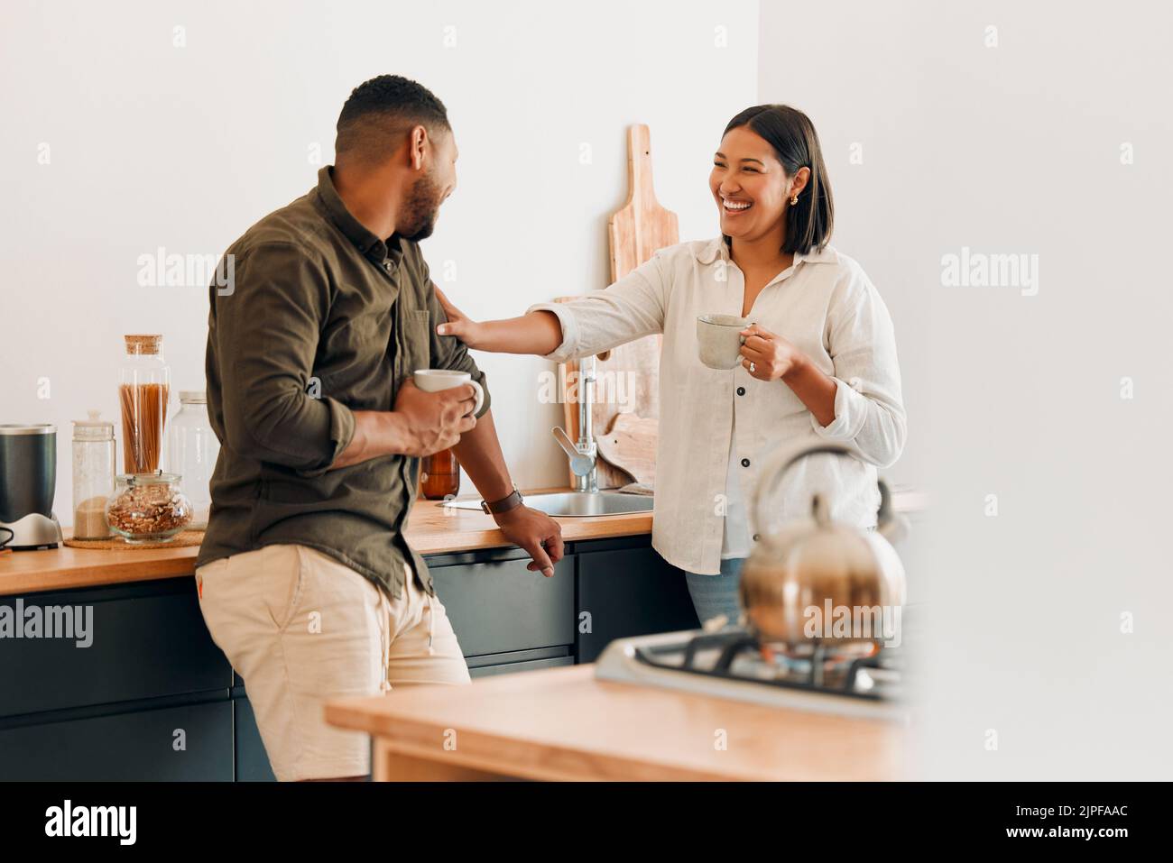 Playful, coffee and loving couple bonding and having fun together in ...