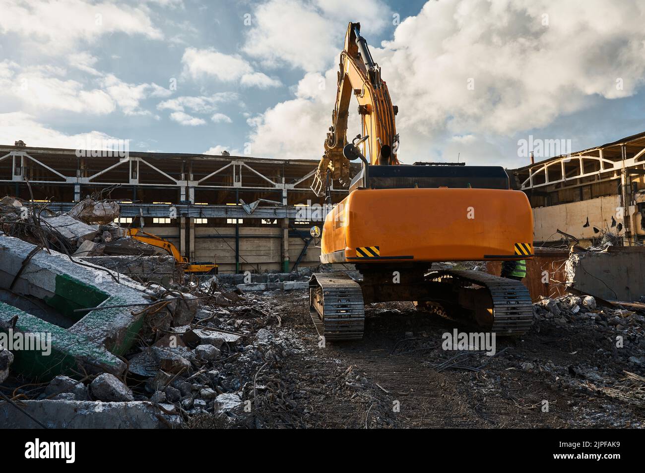 Excavator destroyer equipped with hydraulic scissors Stock Photo - Alamy
