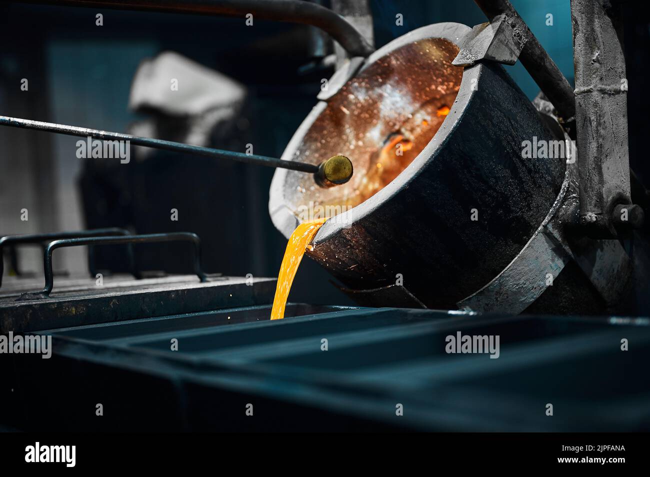 Pouring red liquid silver from bucket in induction oven Stock Photo - Alamy