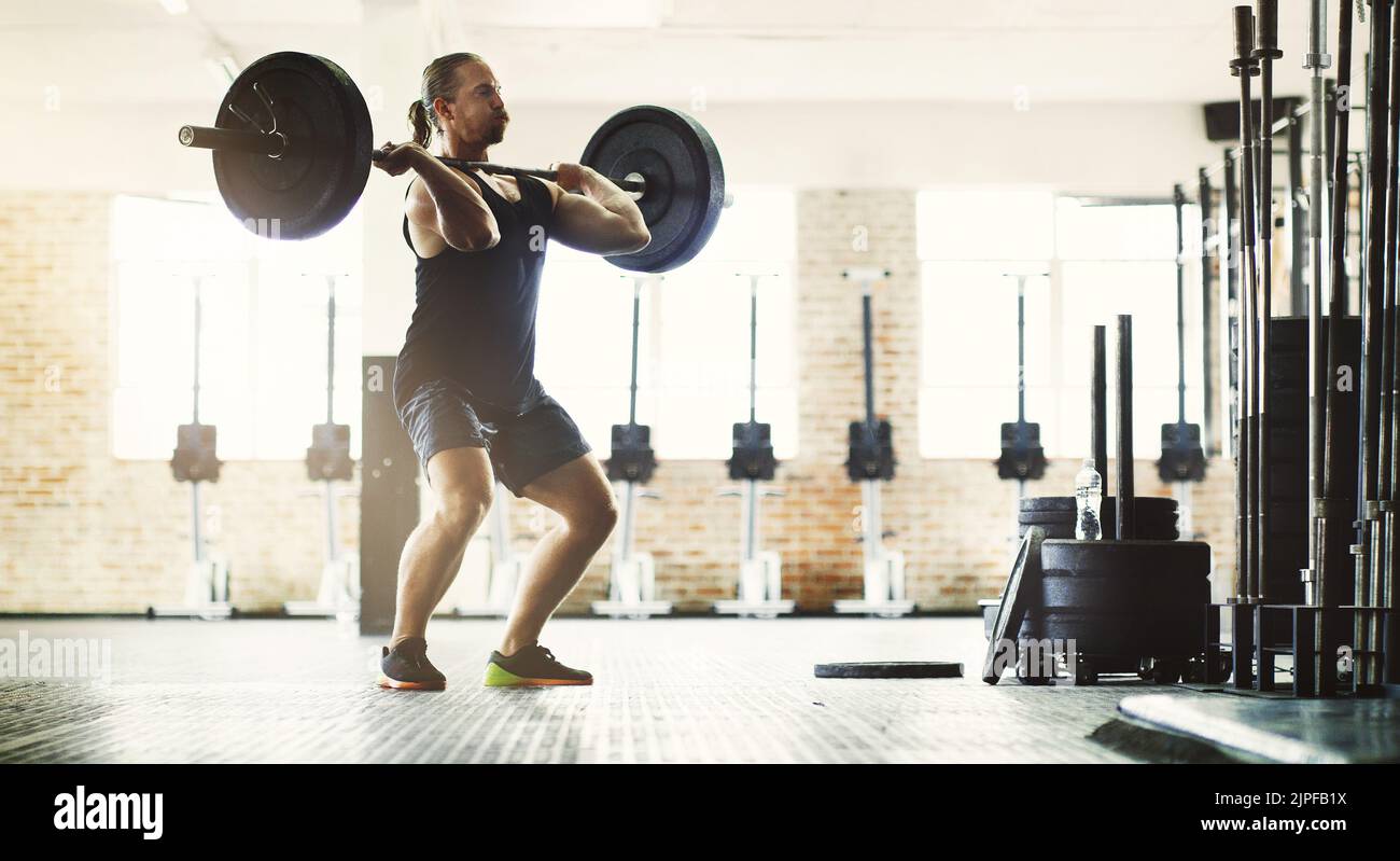 Hes always lifting. Full length shot of a handsome young man lifting ...