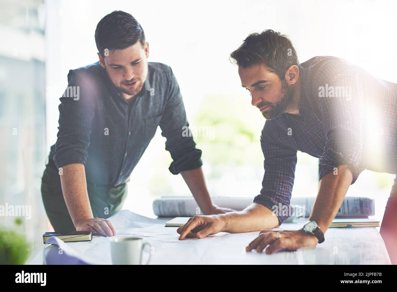 Working hard to deliver the best results to their clients. two young ...