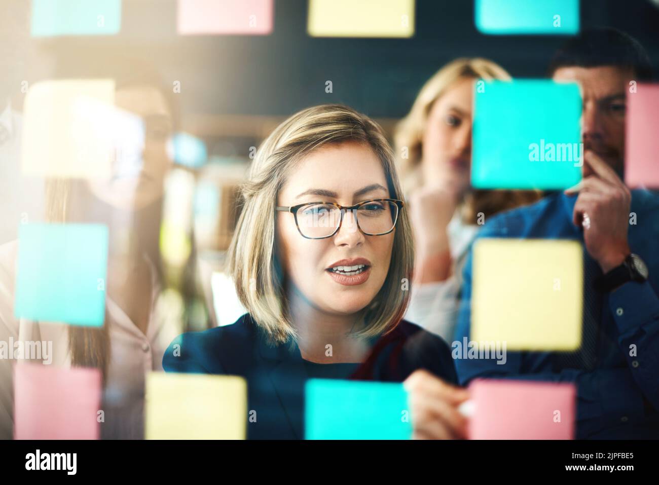 Strong ideas from a strong team. a group of businesspeople arranging ...