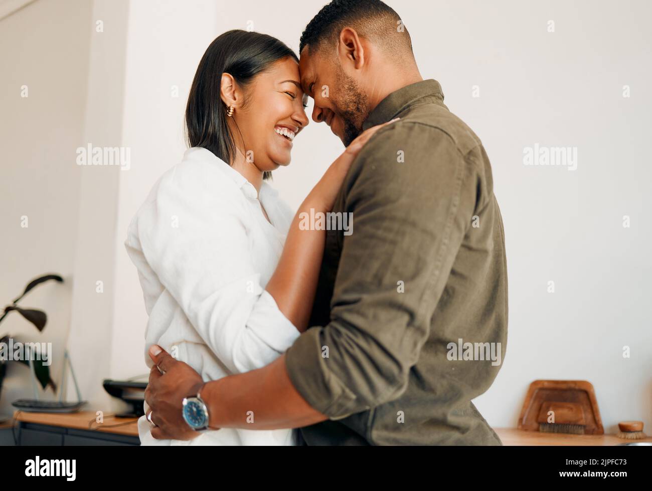 Romantic, laughing and hugging couple bonding, spending time together ...