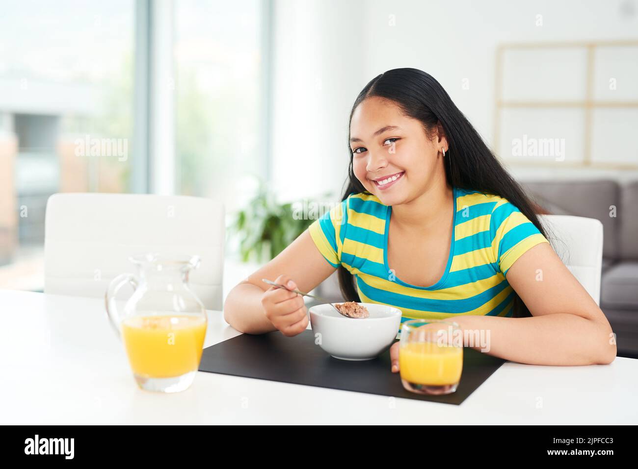 The brightest days start with a healthy breakfast. Portrait of a happy ...