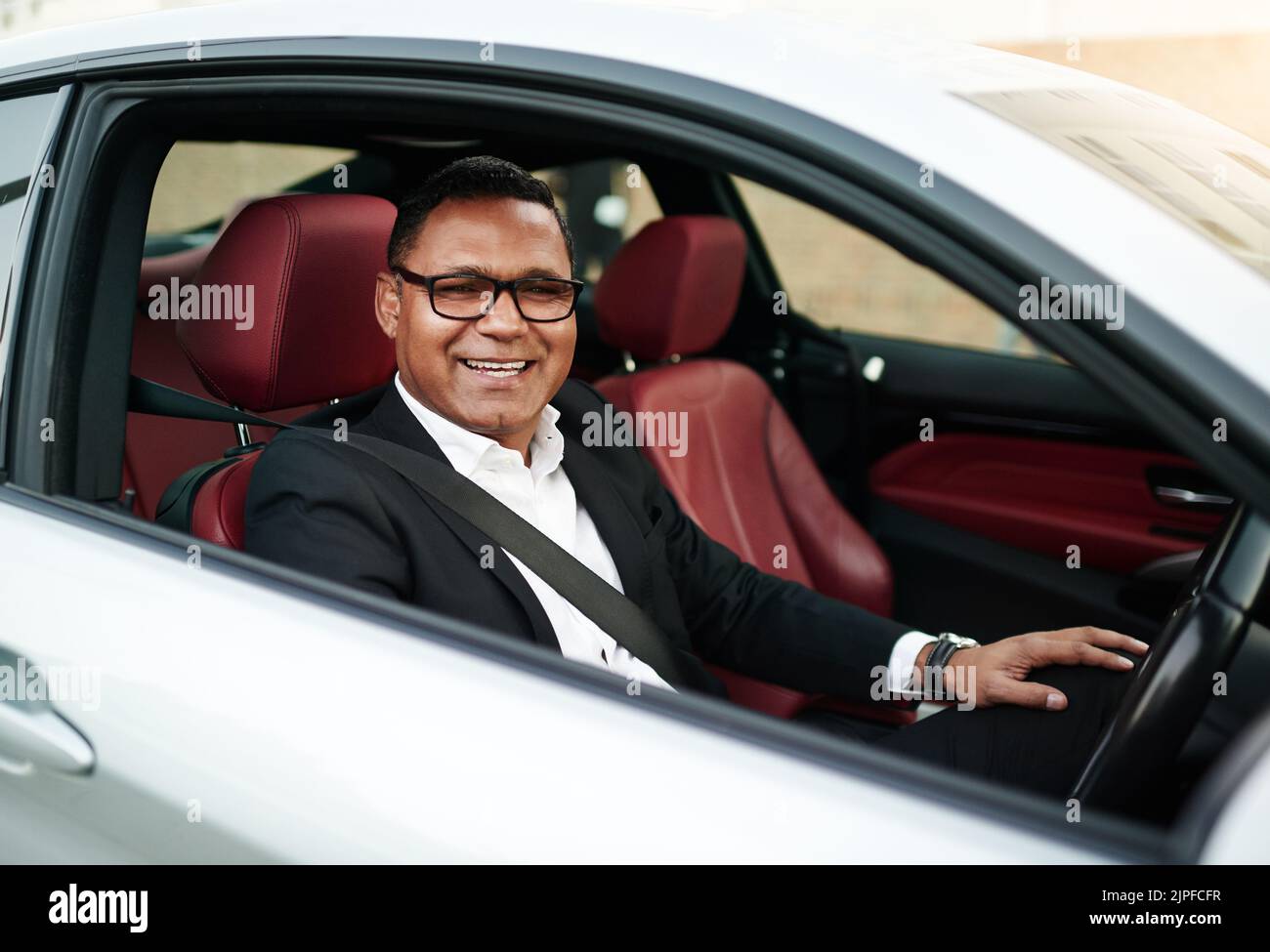 Happy handsome businessman driving car hi-res stock photography and ...