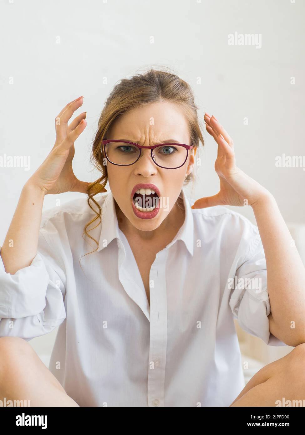 Portrait of young angry woman holding hands in furious gesture. Young ...