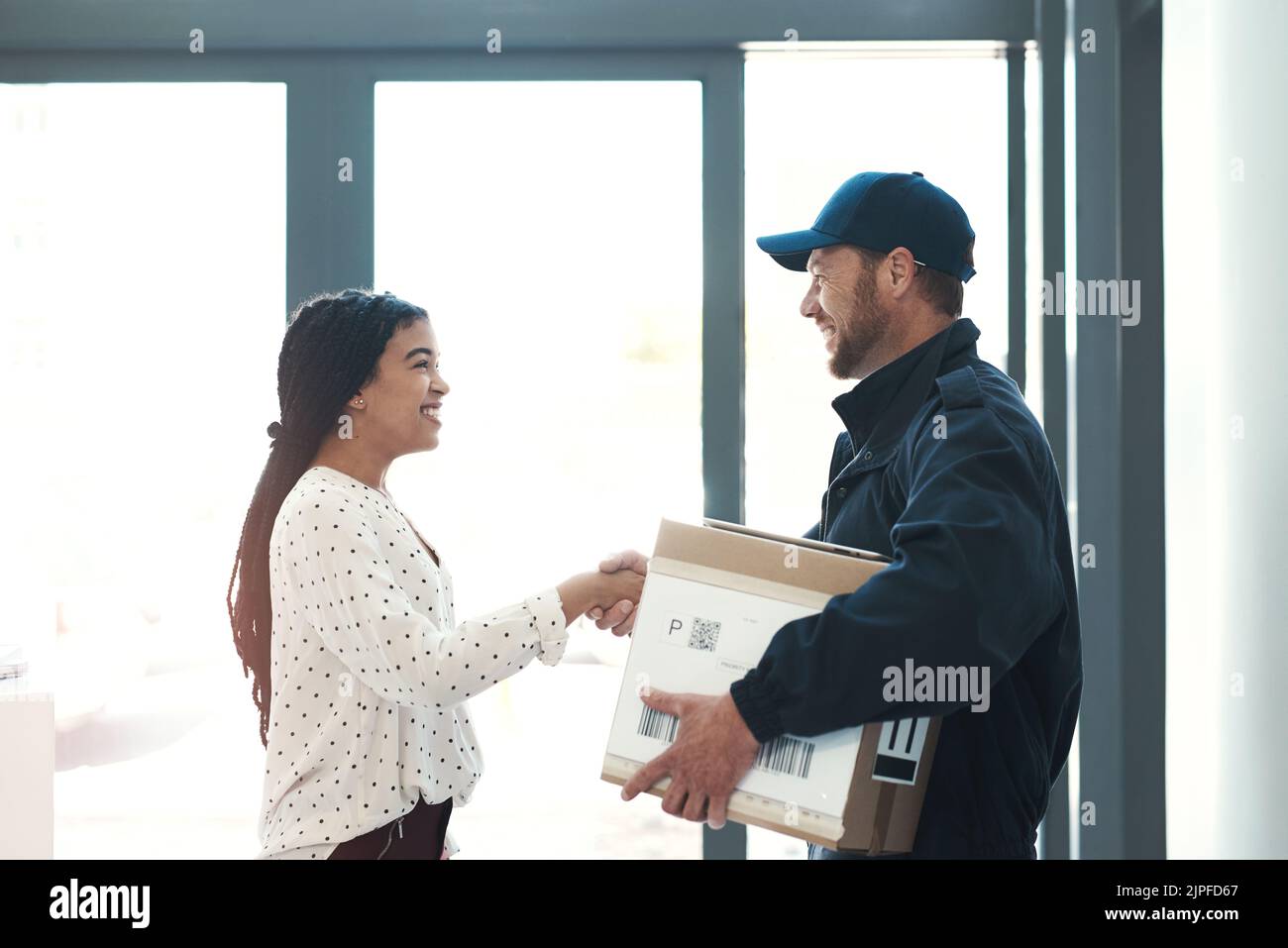 Glad you made it here safe and on time. a handsome delivery man shaking ...