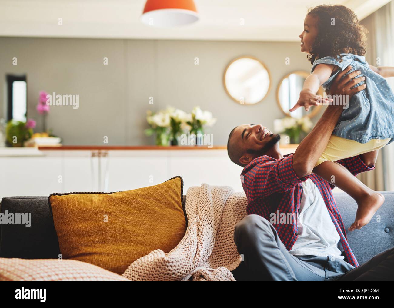 Im not coming back down daddy. an affectionate young father lifting his ...