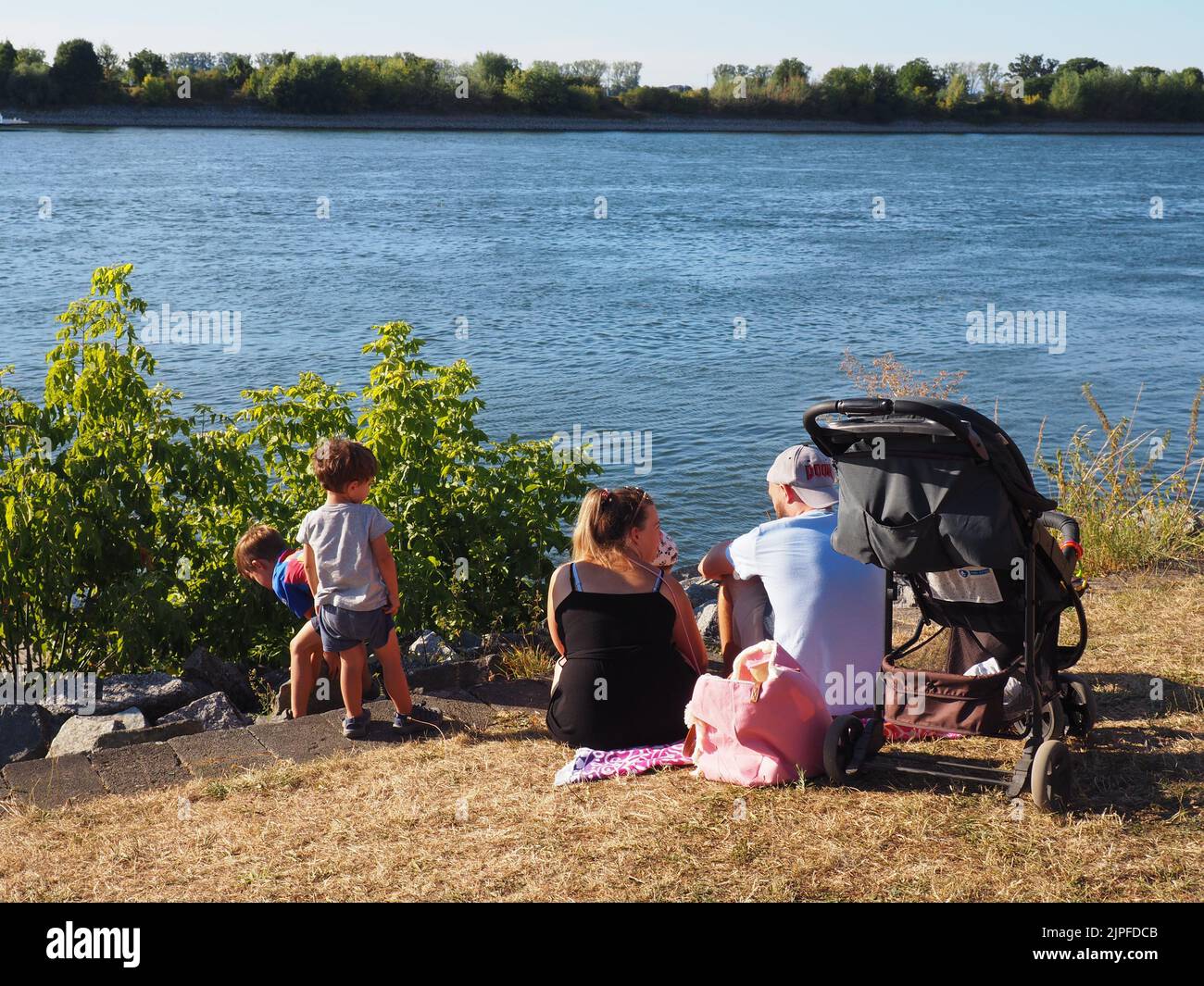 A young family with two children having a picnic on the riverbank Stock ...