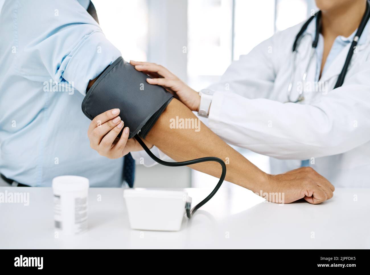 Lets check on your vitals. Closeup shot of a doctor checking a patients ...