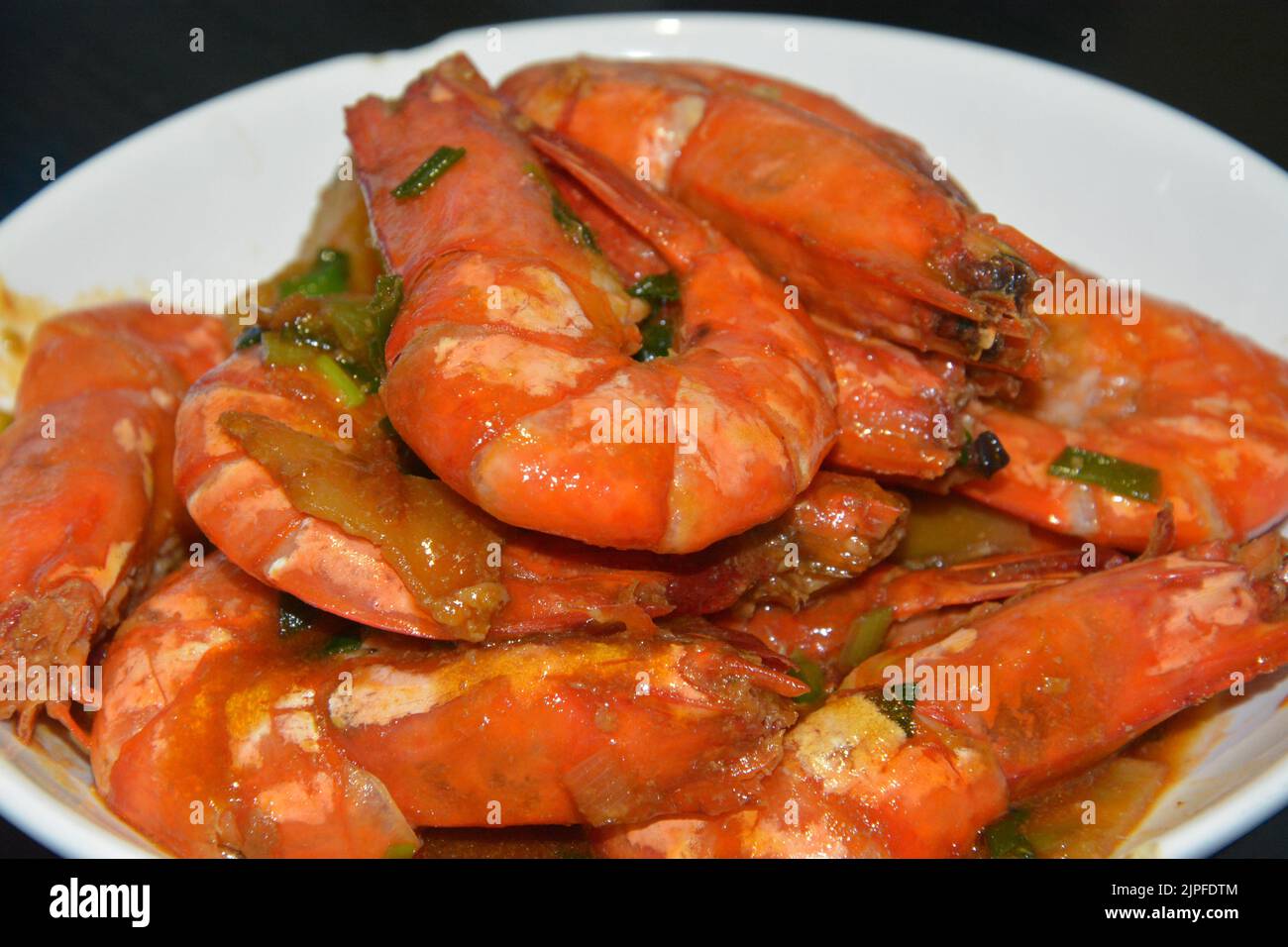 groups of grilled fresh orange shrimp on the plate for eating Stock ...
