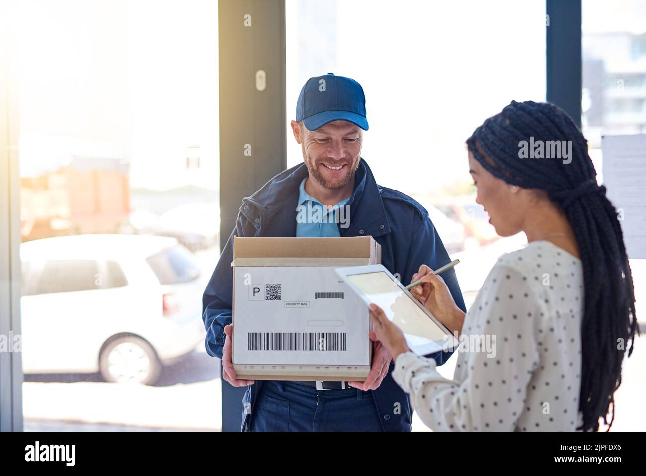 Your signature is all I need. a handsome delivery man getting a ...