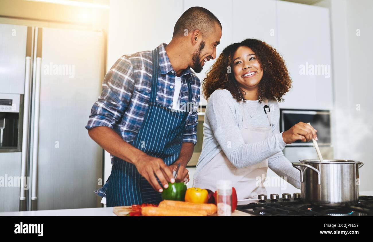 Bonding over cooking. a young couple cooking together at home Stock ...