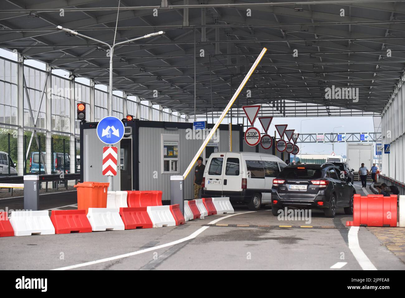 People in cars cross the post-reconstruction checkpoint on the ...