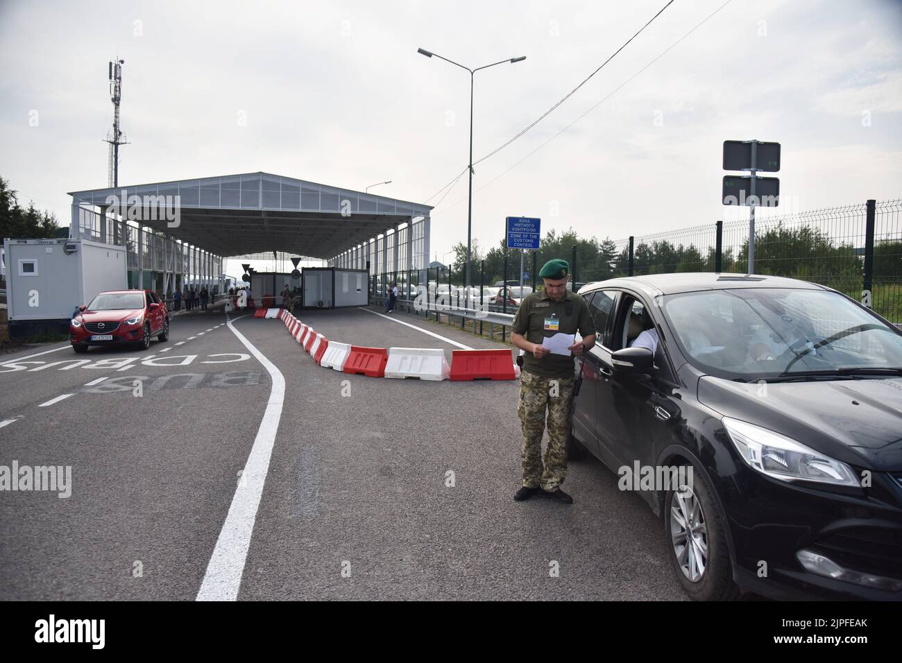 A border guard checks documents at the reconstructed checkpoint on the ...