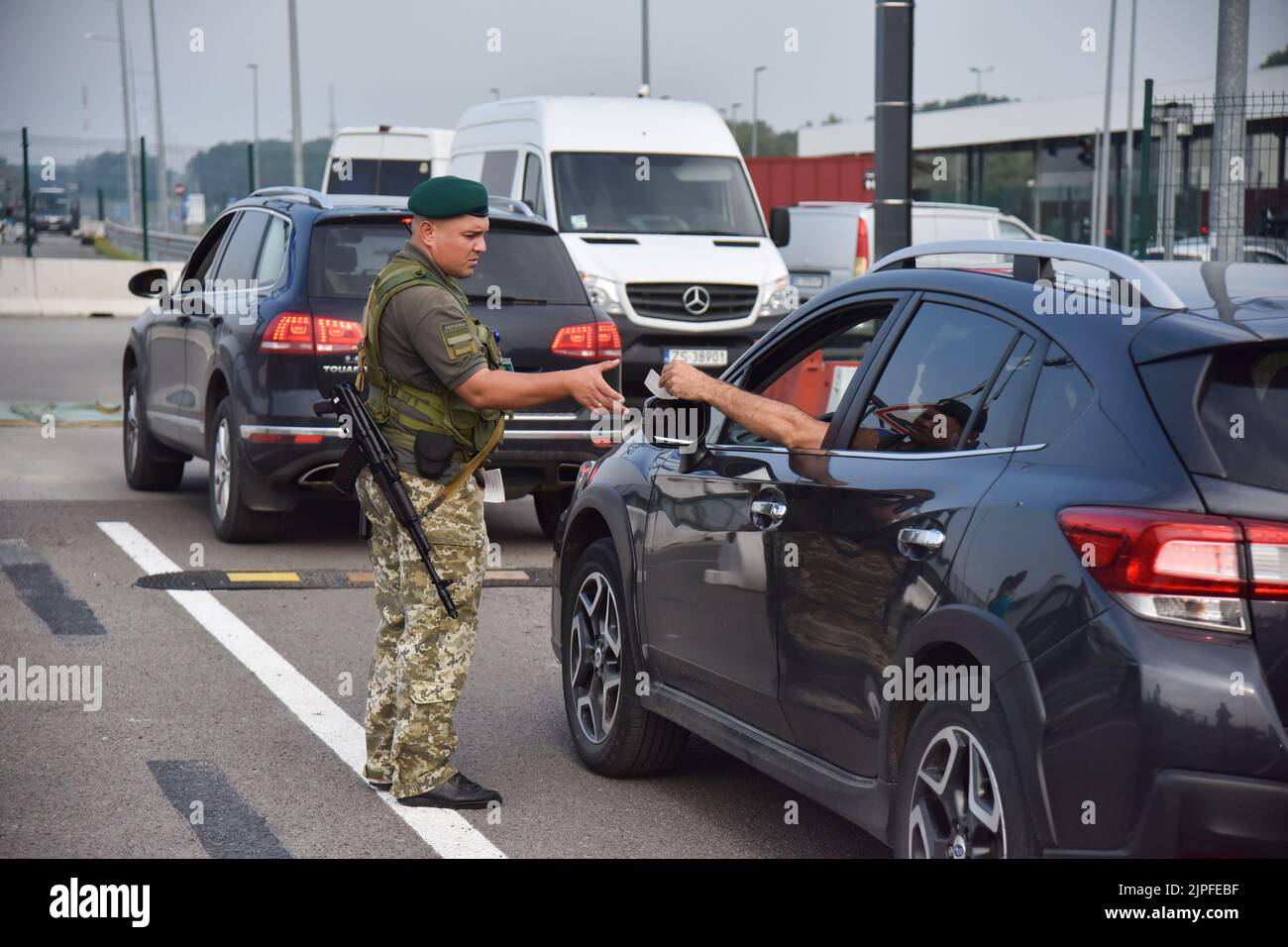 A border guard checks documents at the reconstructed checkpoint on the ...