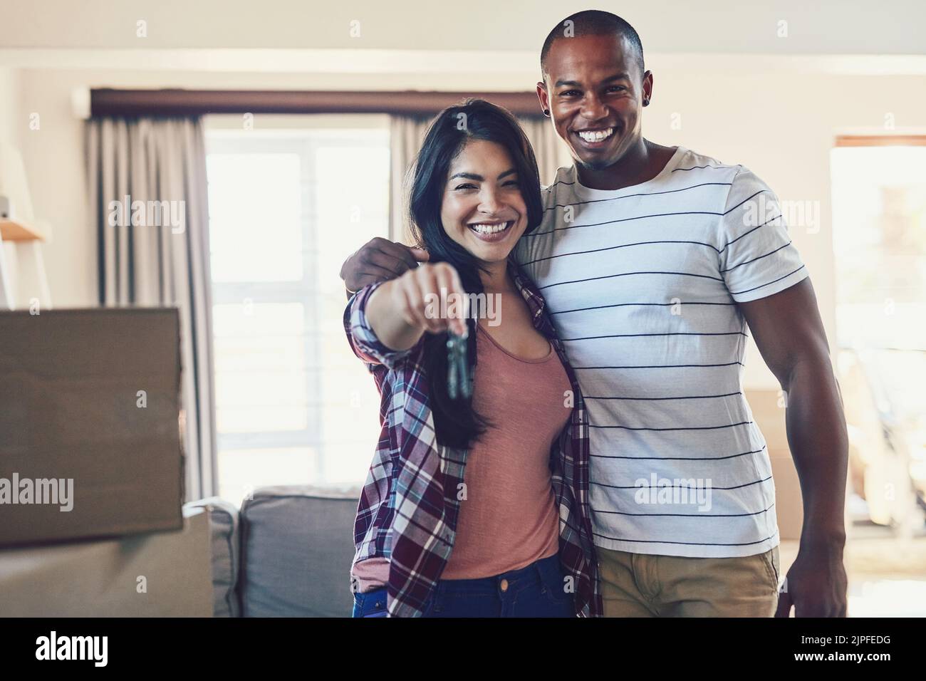 This is a huge milestone for us. Portrait of a young couple holding the ...