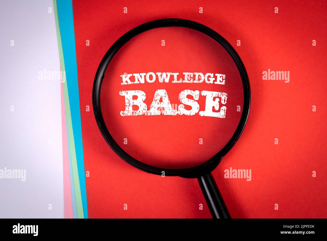 Knowledge base. Search and research concept. Magnifying glass on a red ...